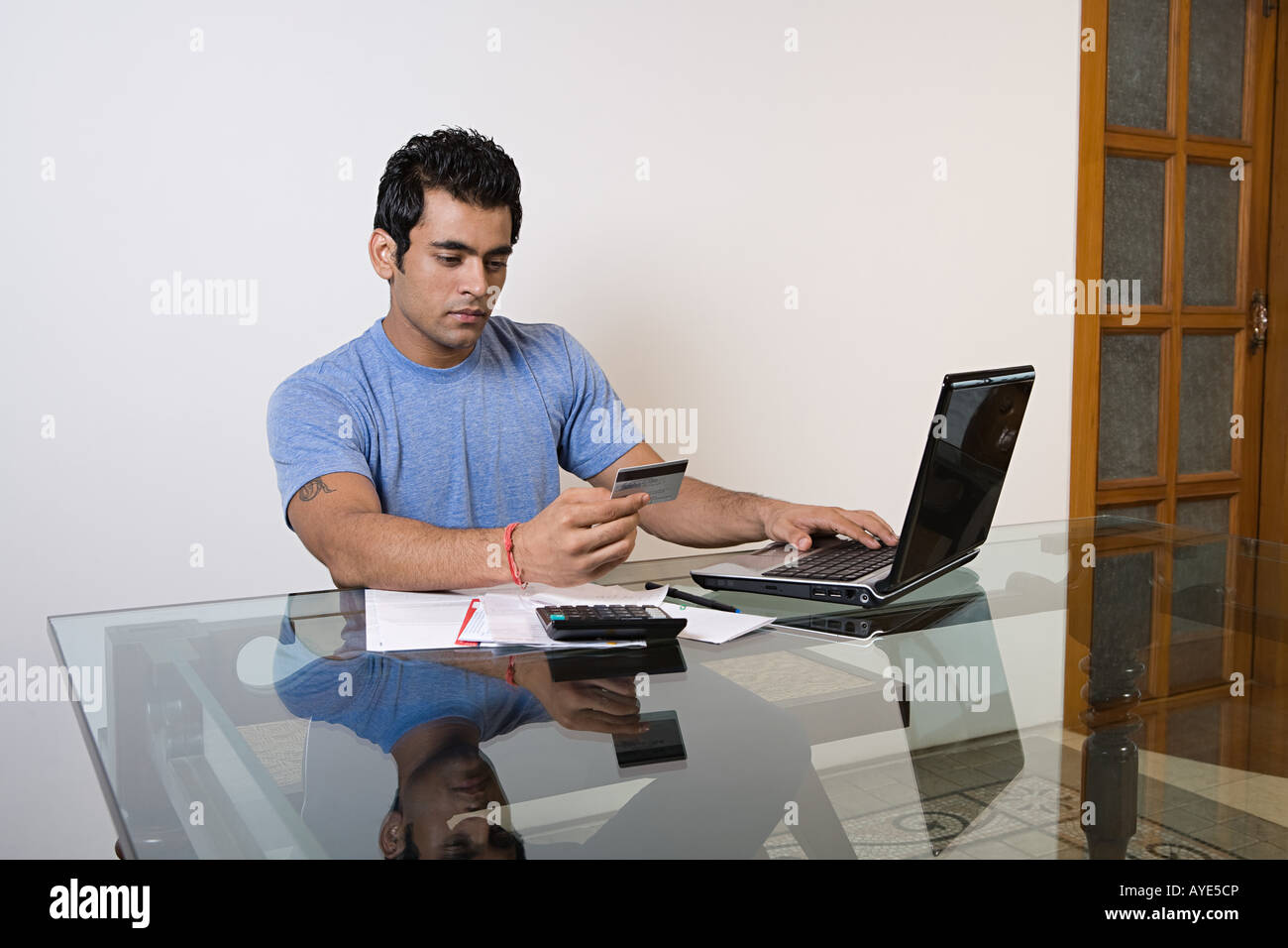 A man sorting his finances on a laptop Stock Photo - Alamy