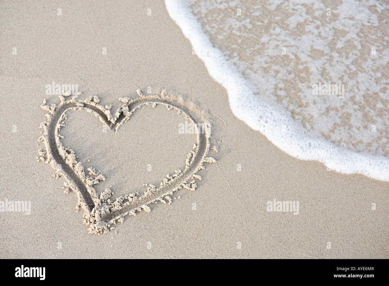 Heart shape in the sand Stock Photo - Alamy