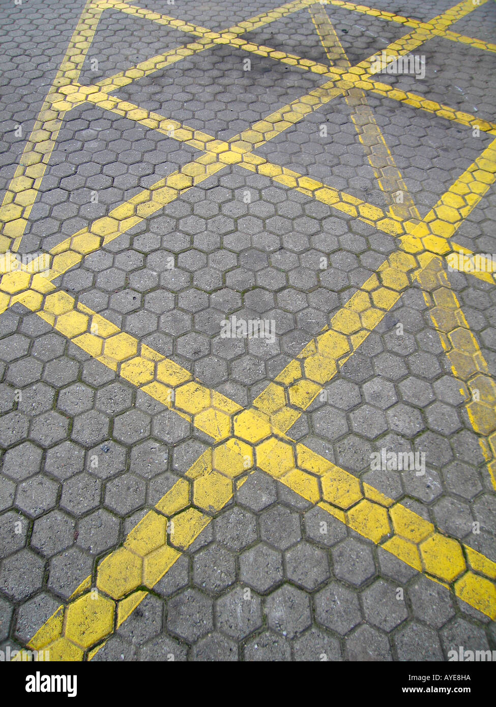 Yellow box markings on block paviors Stock Photo - Alamy