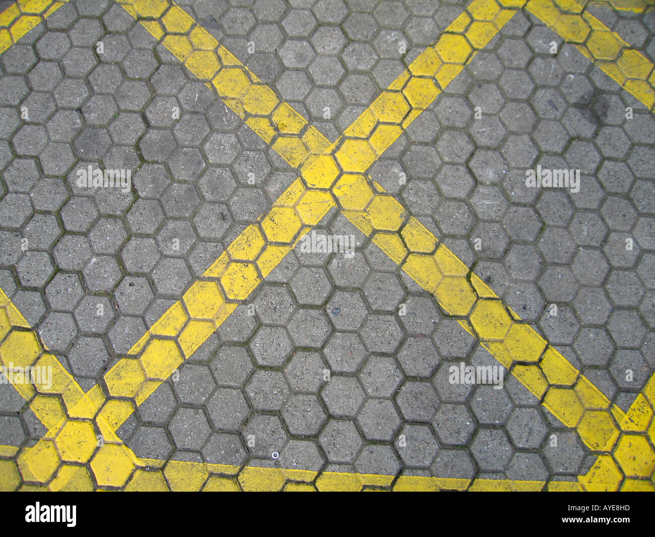 Yellow box markings on block paviors Stock Photo - Alamy