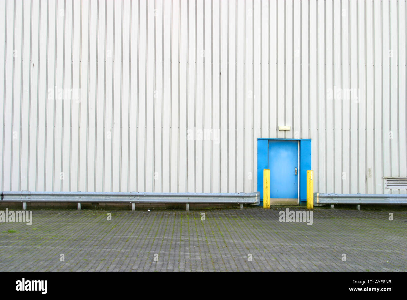 Blank factory wall with fire exit door Stock Photo - Alamy