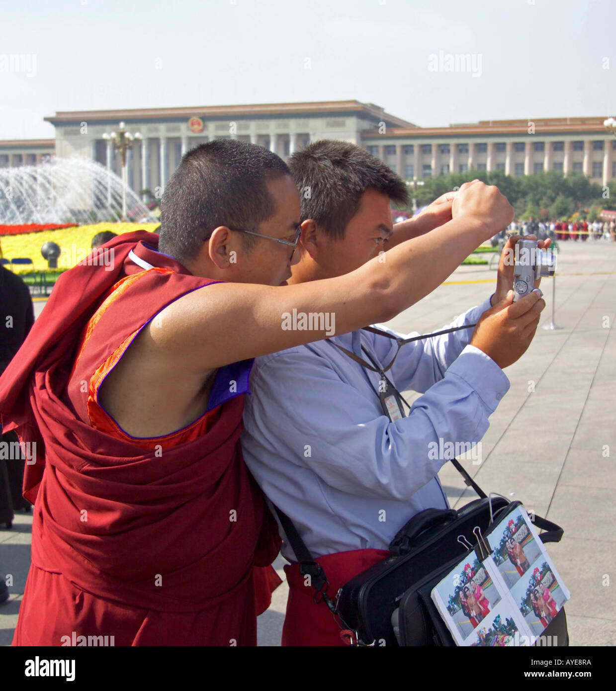 monk helping to take photos in Tiananmen Square Stock Photo - Alamy