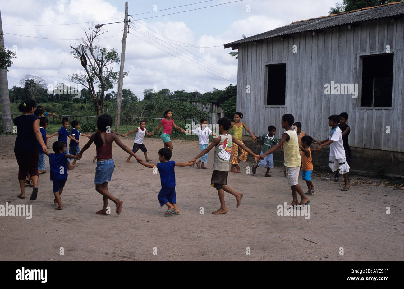 River Amazon primary school Children playing circle game in playground ...