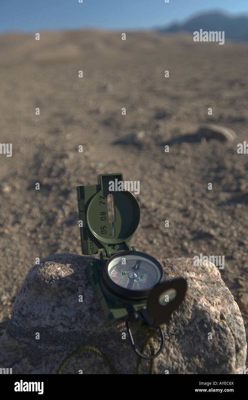 Military style lensatic compass sitting on a rock Stock Photo - Alamy