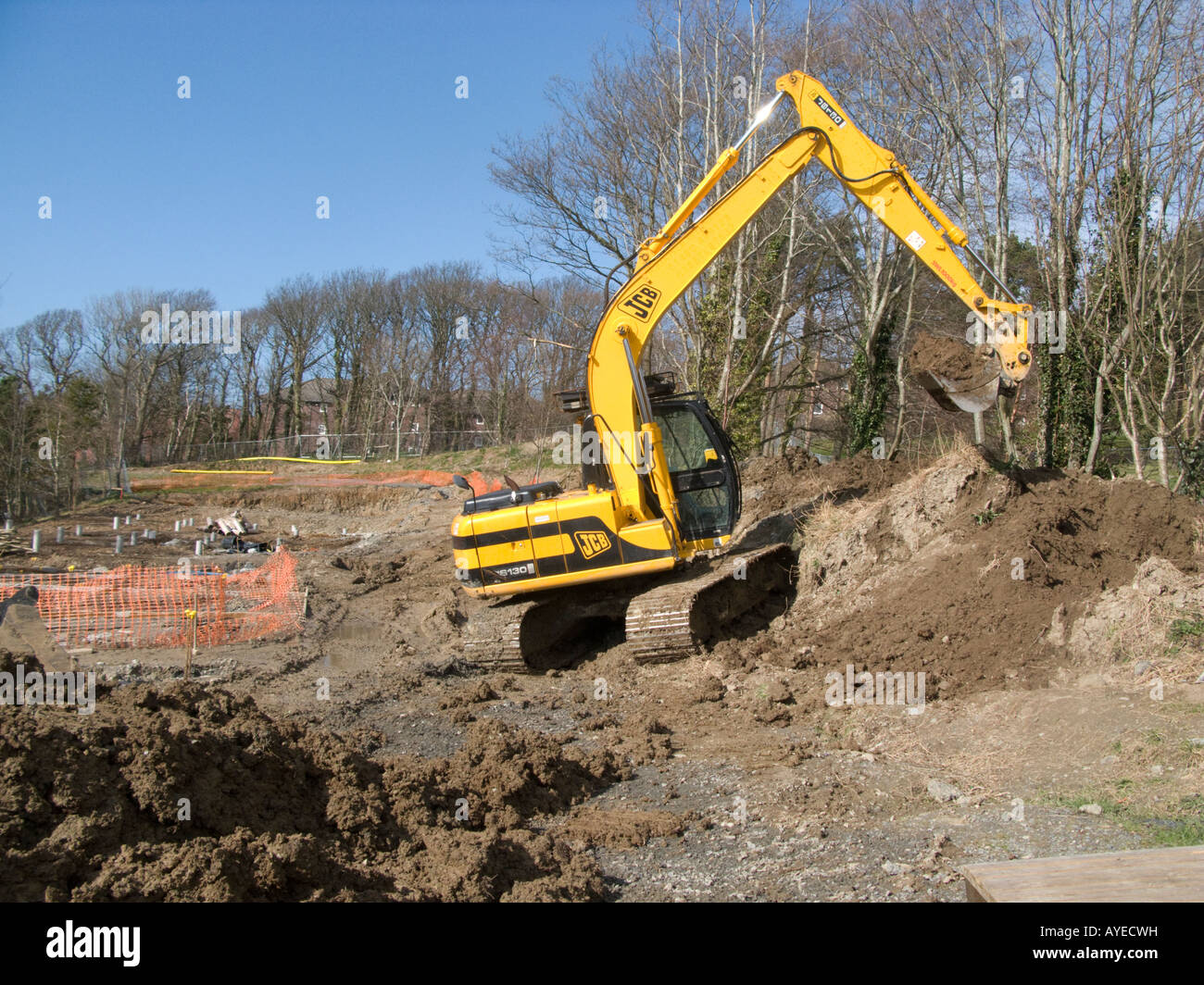 yellow JCB digger clearing land in preparation for building work Stock ...