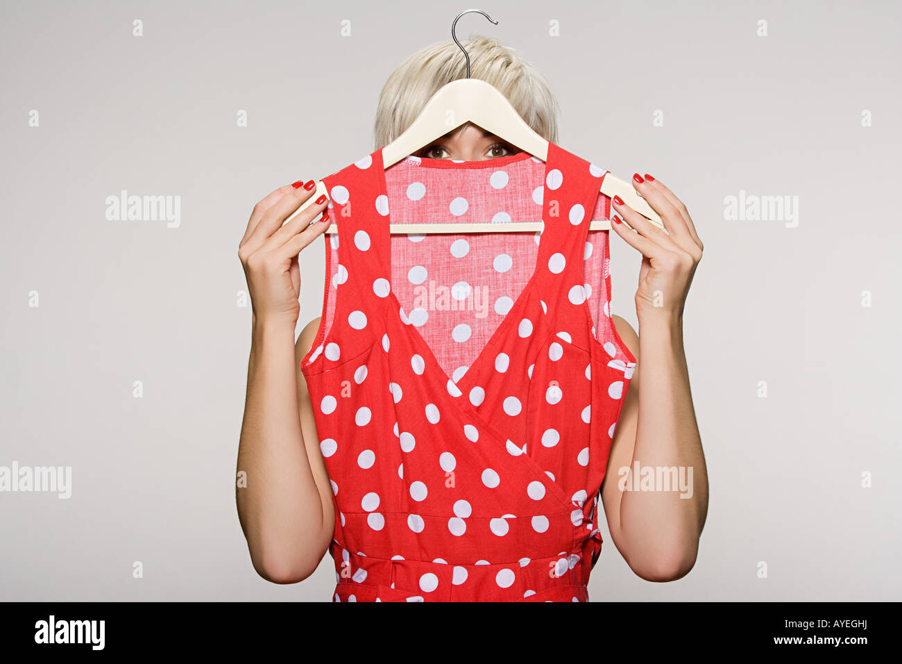 Woman holding dress Stock Photo - Alamy