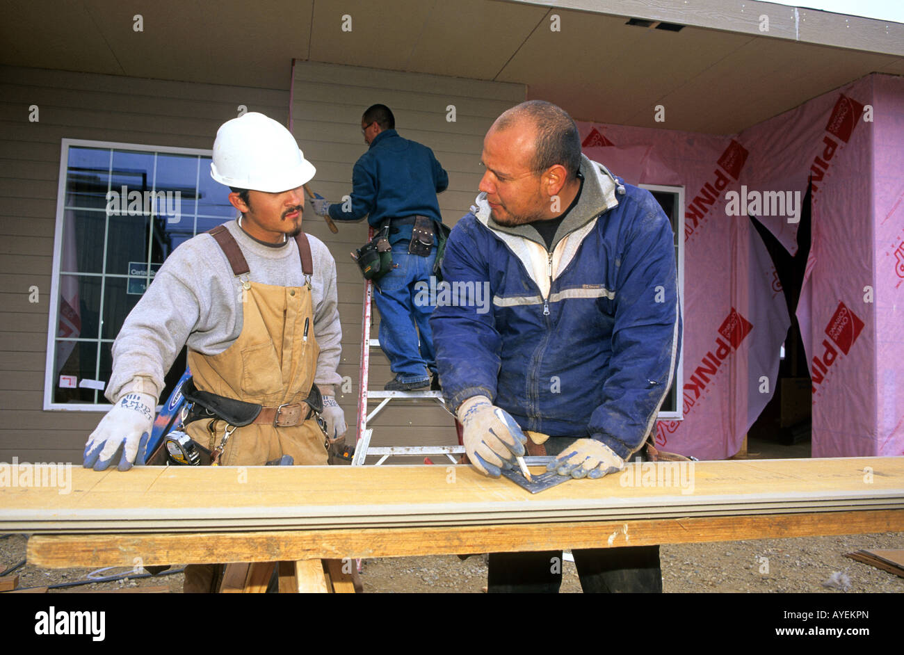 Apprentice at left taking direction from a Journeyman on a construction ...