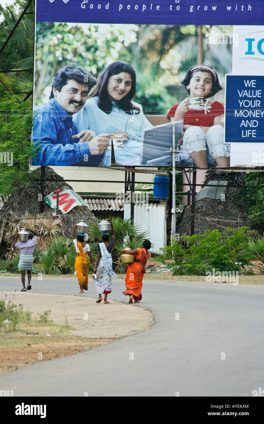 Women Carrying Water Under Billboard of Family Using Computer in Tamil ...