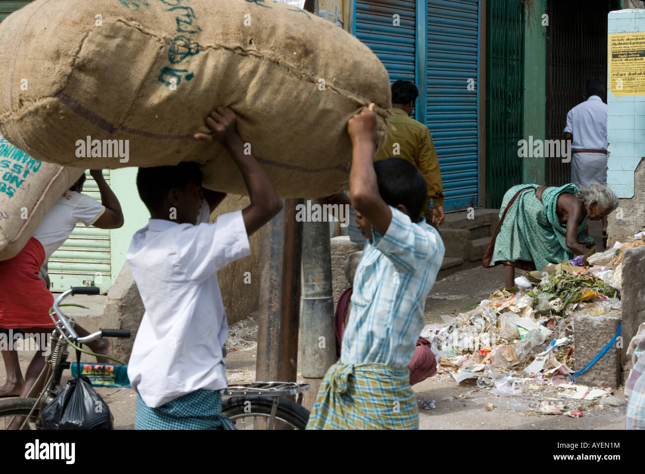 Young Men Lifting Heavy Sack PoorWoman Picking through Garbage in ...