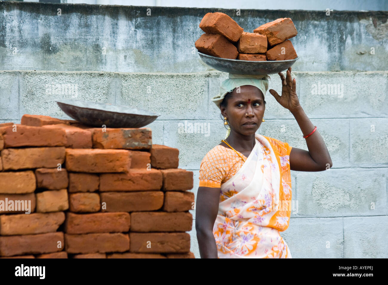 Women carrying bricks hi-res stock photography and images - Alamy
