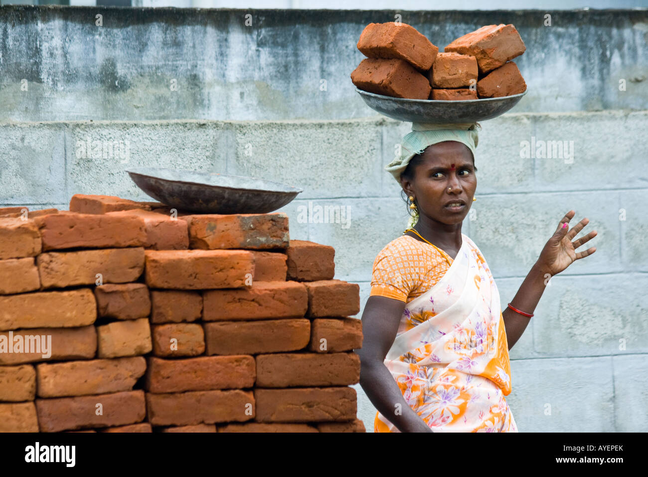 Women carrying bricks hi-res stock photography and images - Alamy