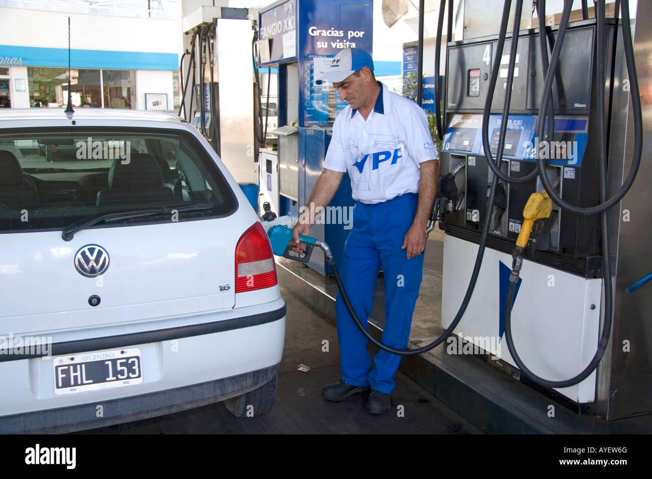 YFP gas station attendent fueling up a car in Mendoza Argentina Stock ...