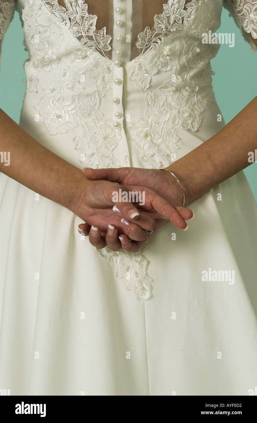 Bride with fingers crossed behind back Stock Photo - Alamy