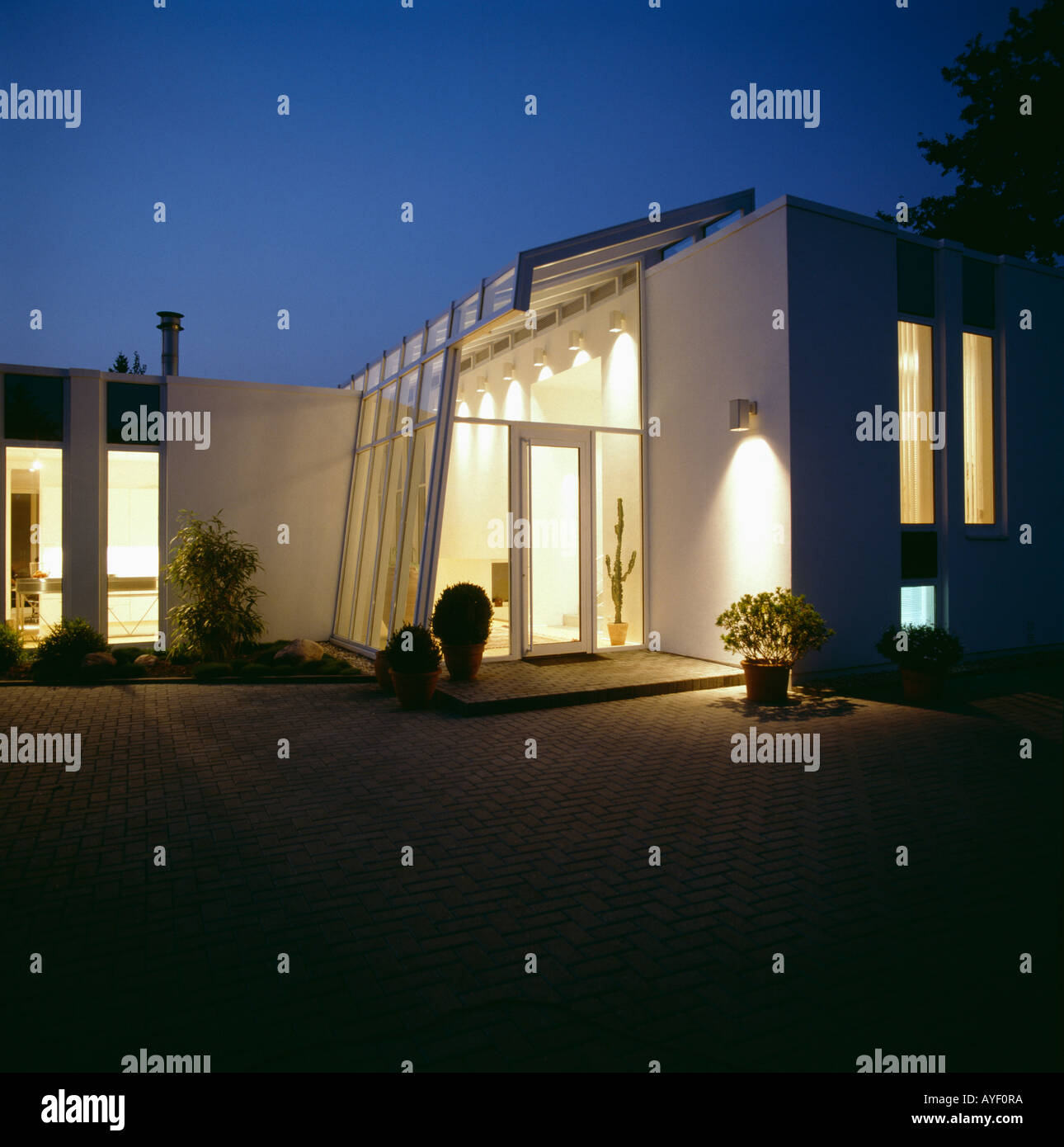 Modern house with lighted windows Stock Photo - Alamy