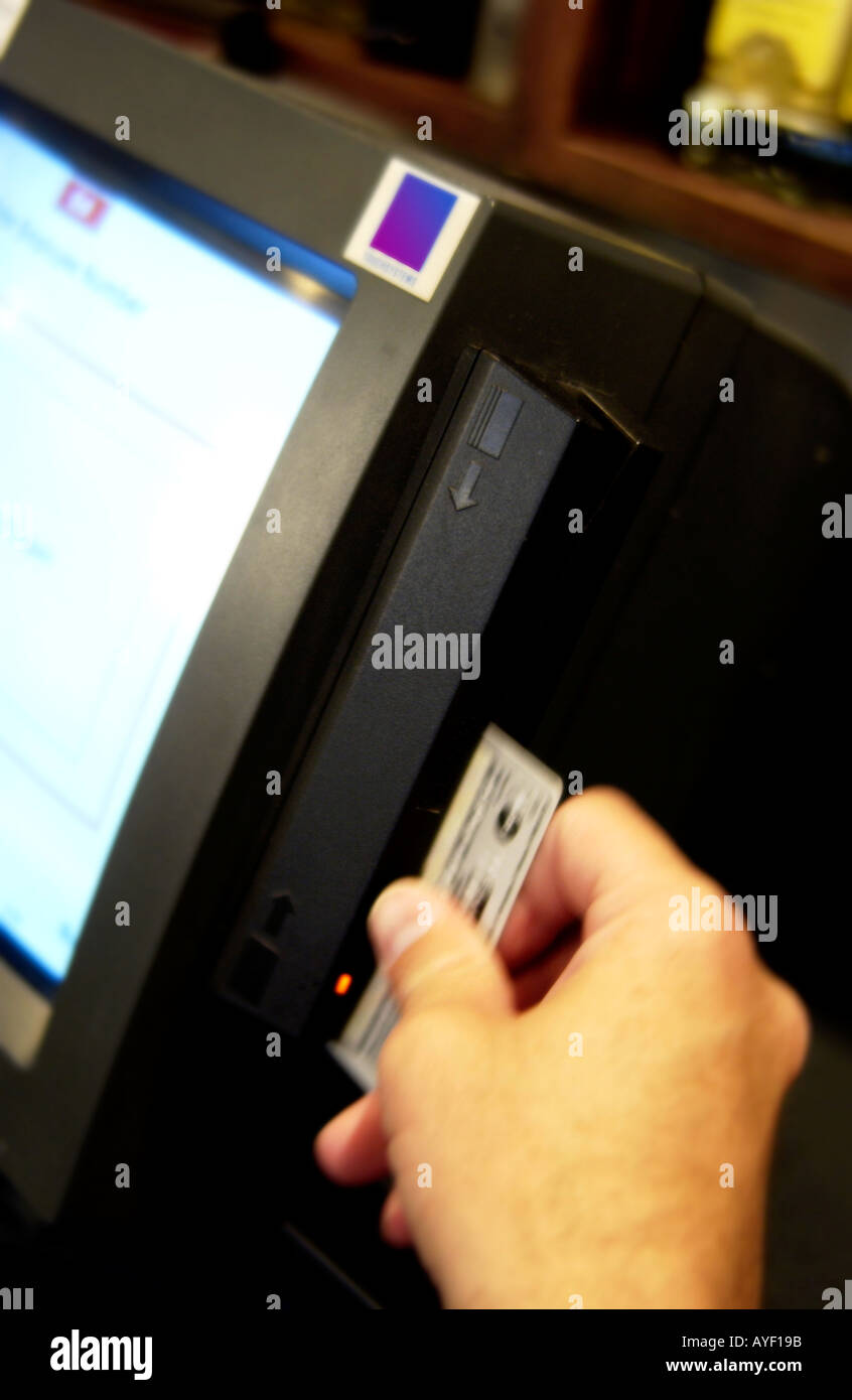 Mans hand swiping credit card through cash register Stock Photo - Alamy