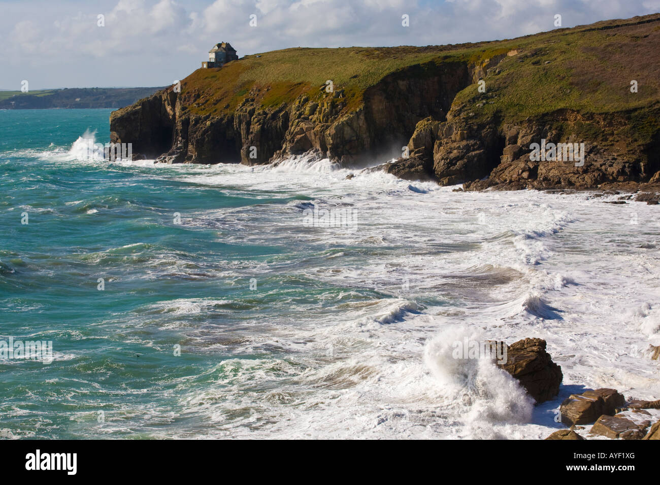 Waves crashing into Rinsey Cove and Cliffs with Rinsey Head in the ...