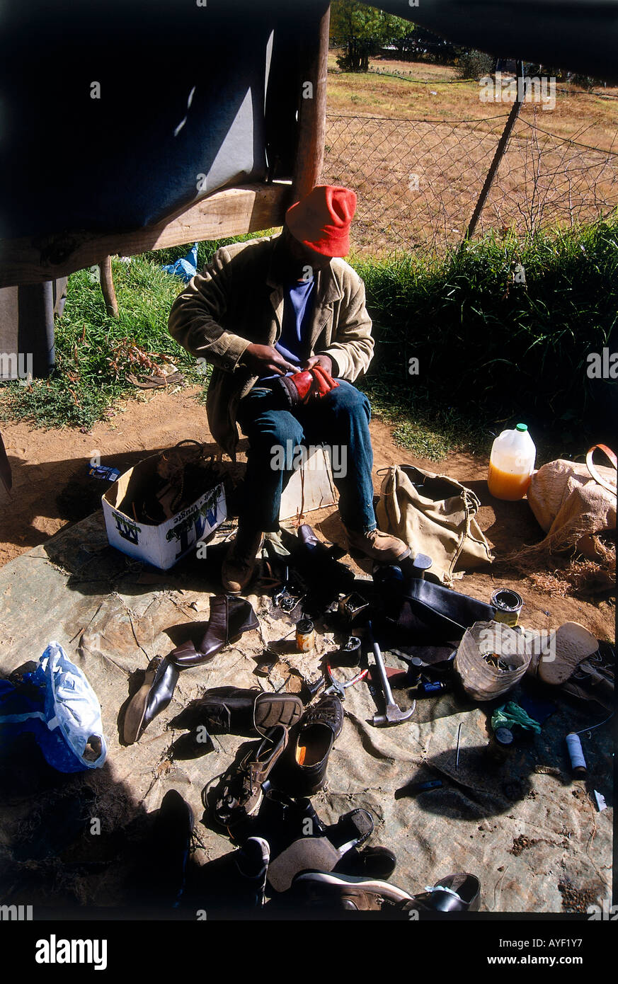 A Basotho man mending shoes at Magoebaskloof Stock Photo - Alamy
