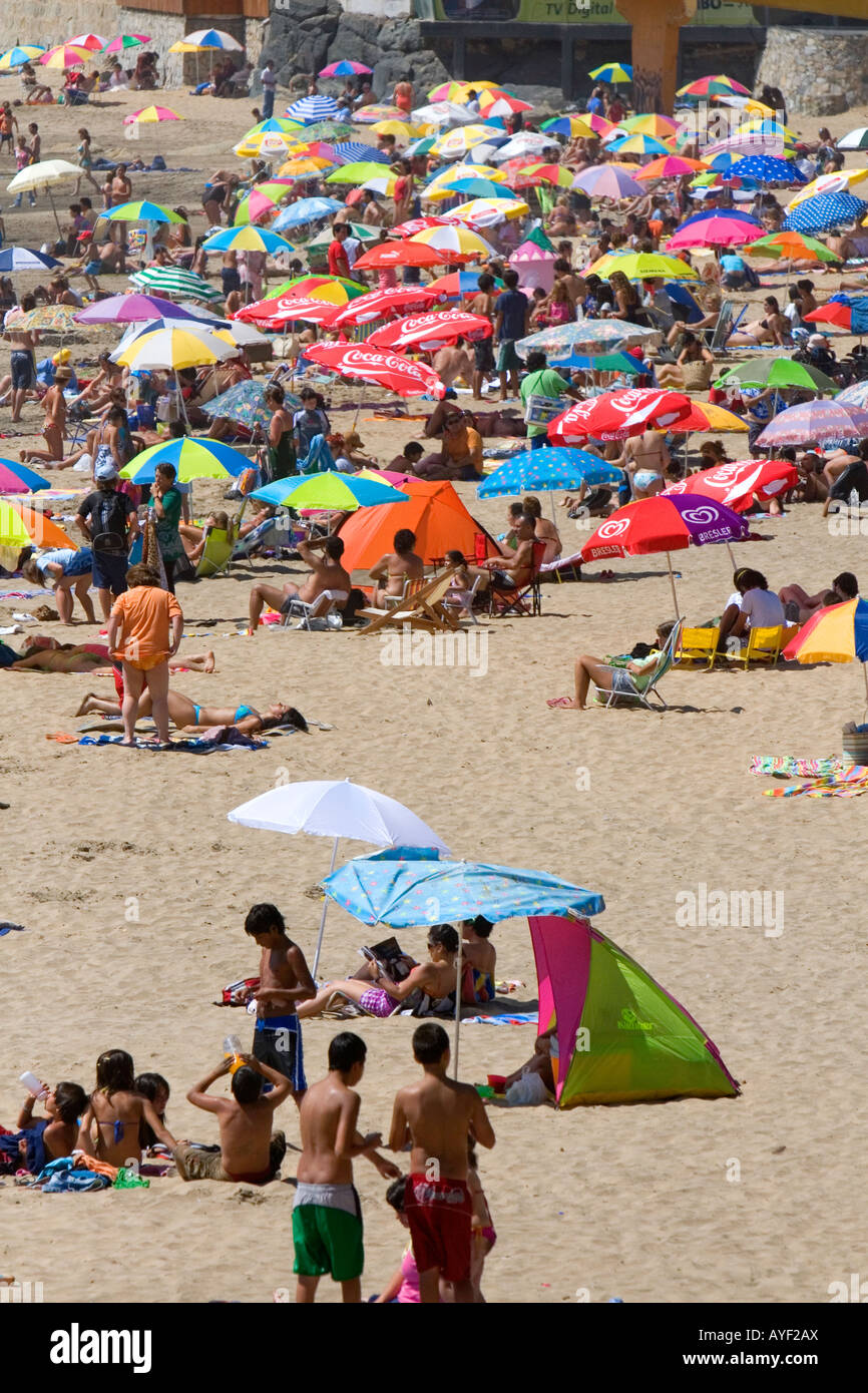People sit under umbrellas for shade on the beach at Concon Chile Stock ...