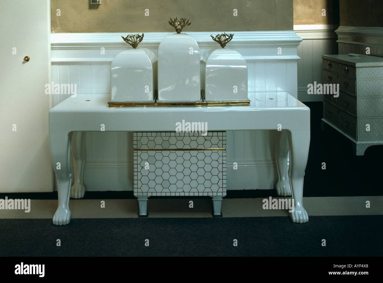 Collection of white china jars on white console table Stock Photo - Alamy