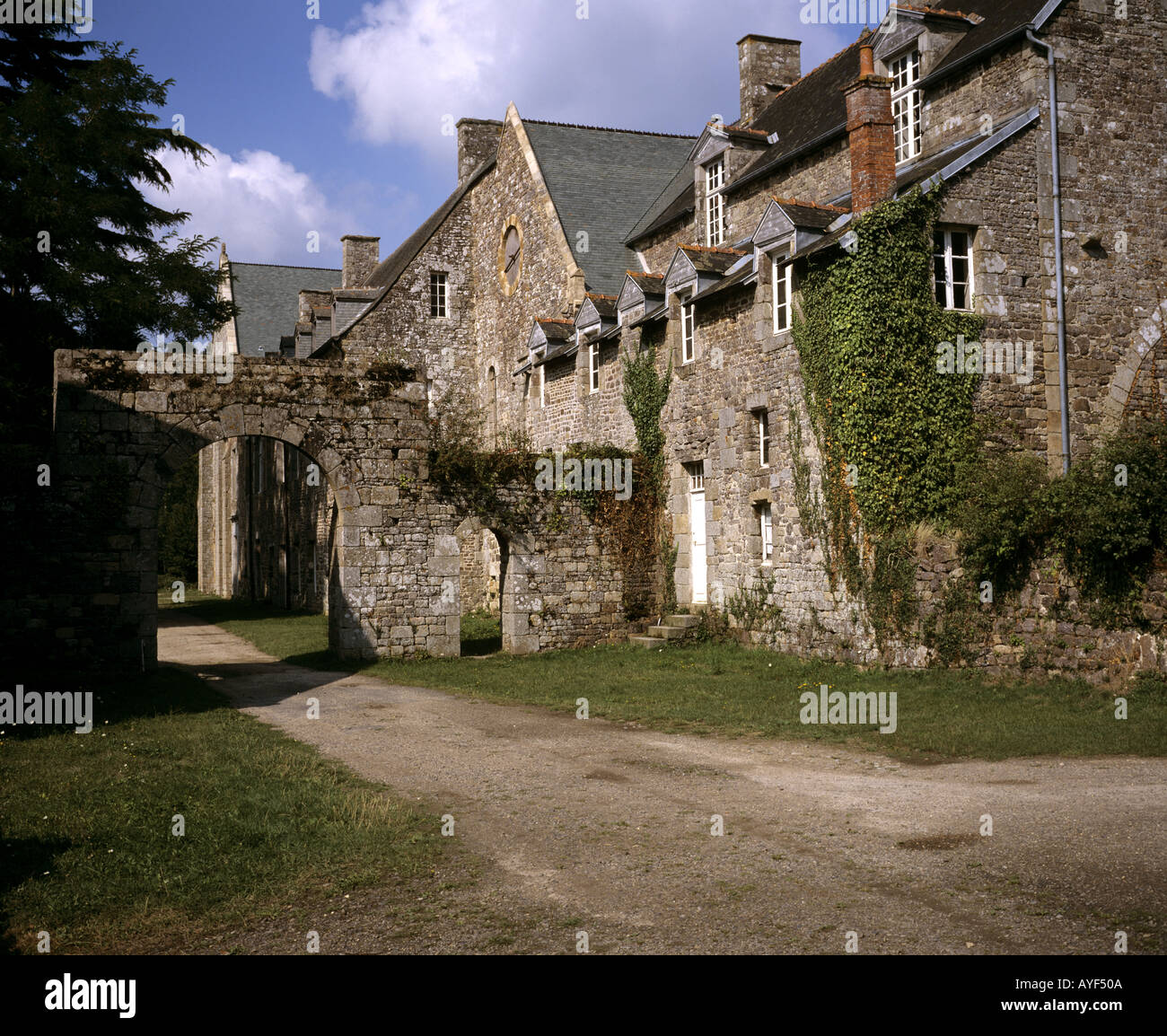 Arched gateway and buildings at the 12th century Abbaye de La Lucerne ...