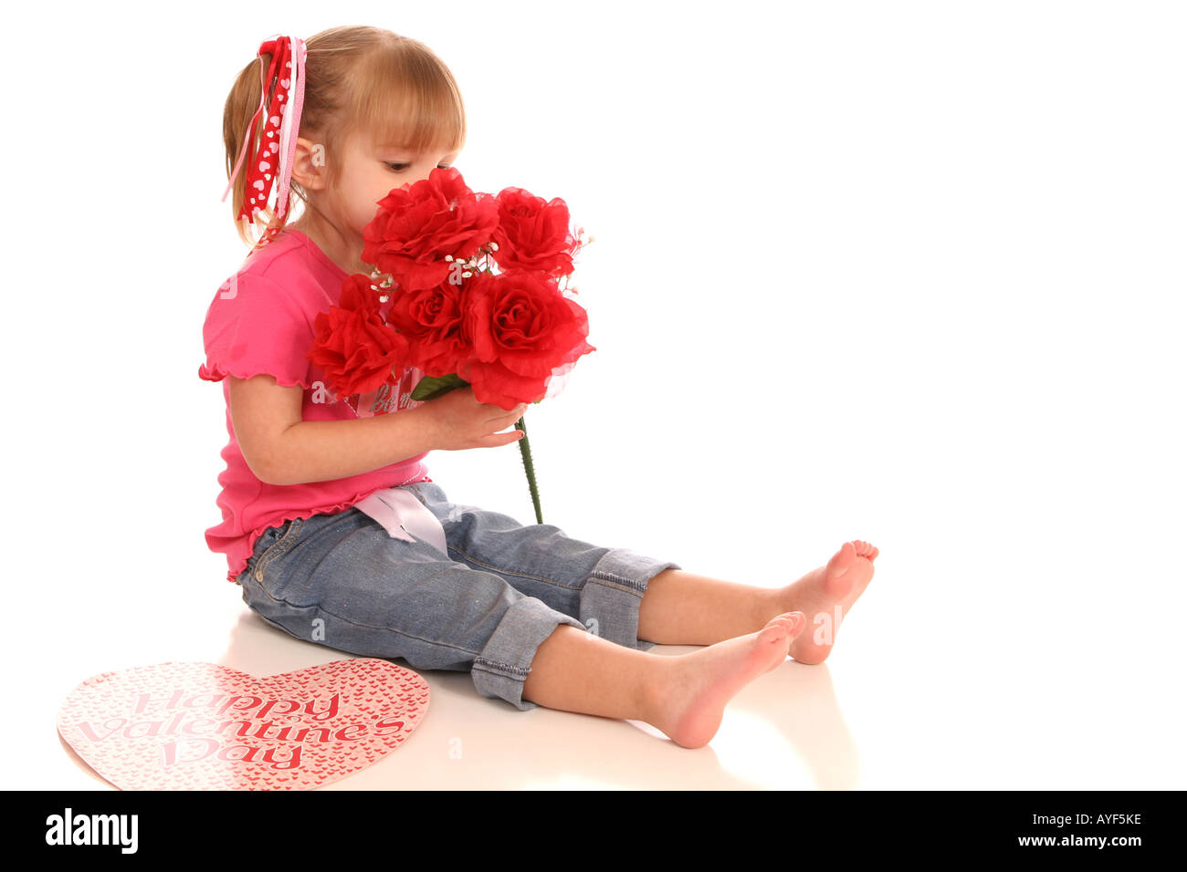 Valentine girl smelling roses Stock Photo - Alamy
