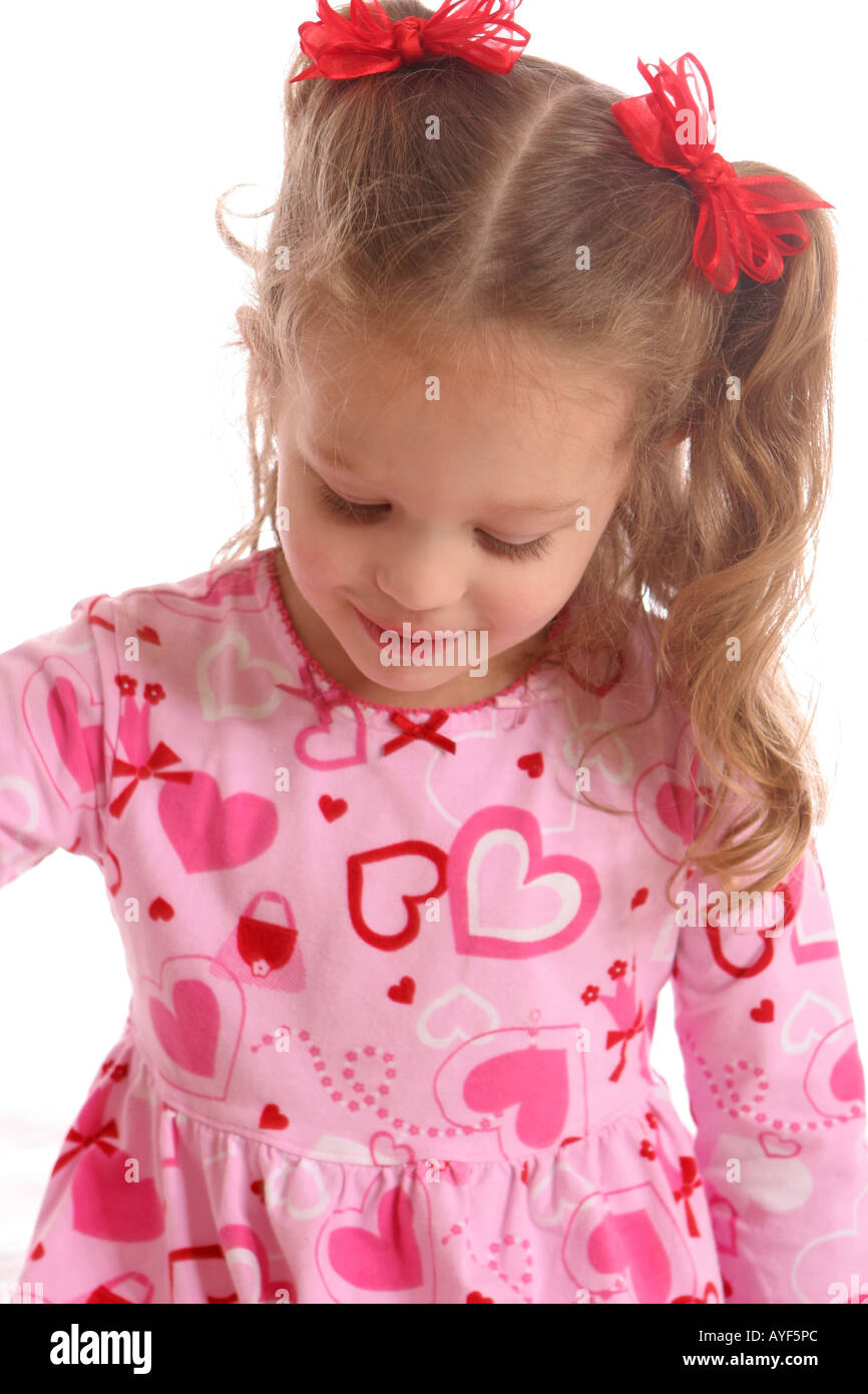 Little girl standing looking down Stock Photo - Alamy