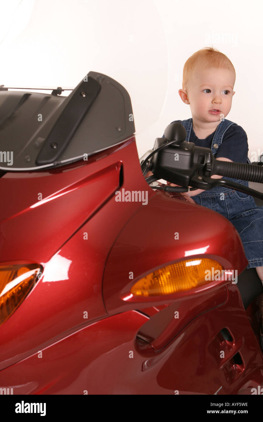 Little redhead on red motorcycle Stock Photo - Alamy