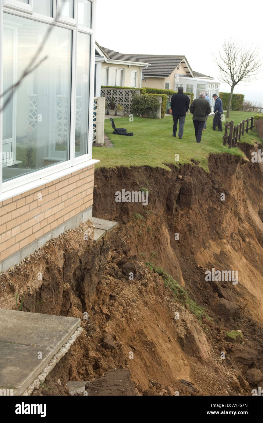 Residents in garden by cliff landslide at Knipe Point, Yorkshire, UK ...