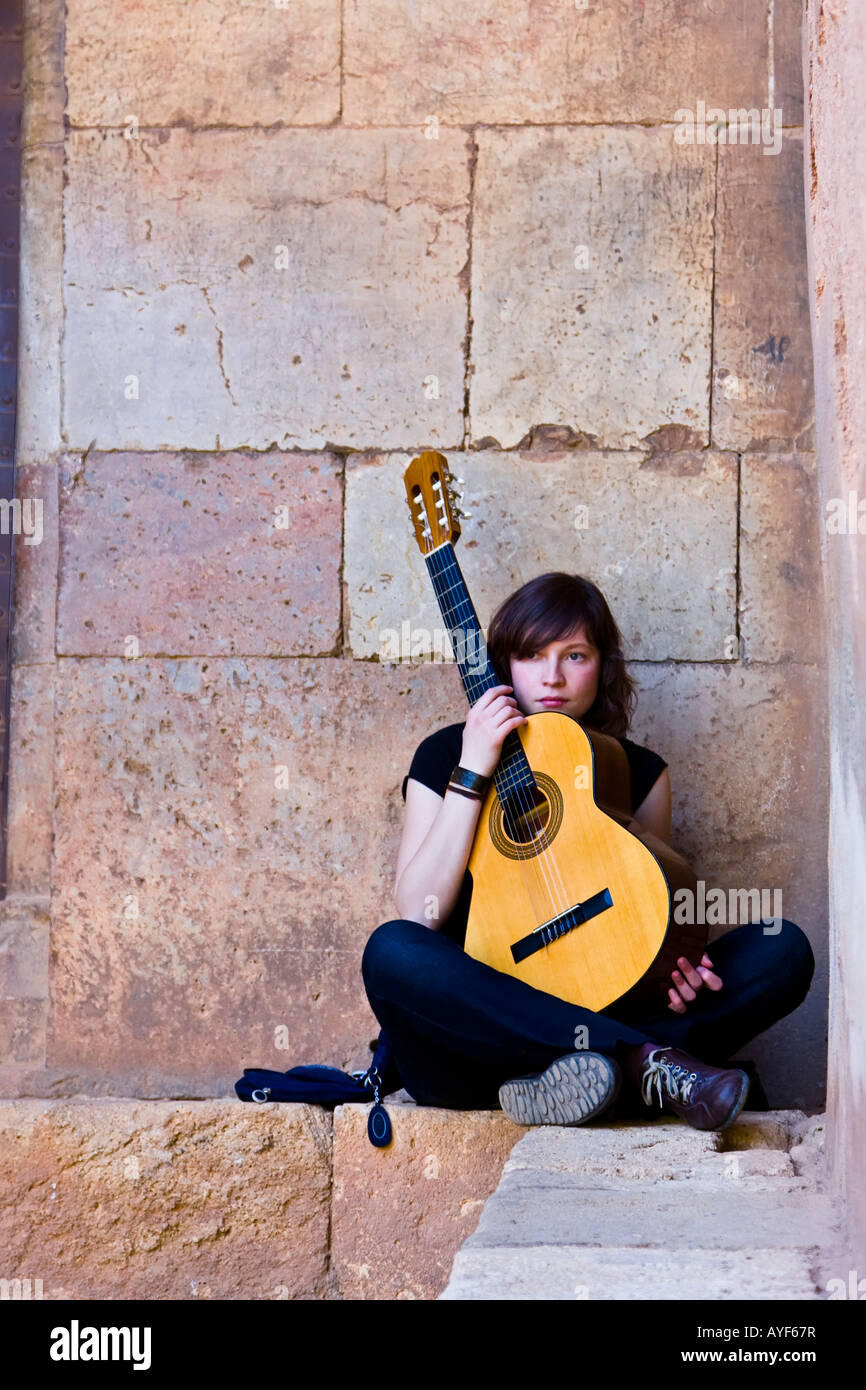 Young guitar performer against brickwall Stock Photo - Alamy