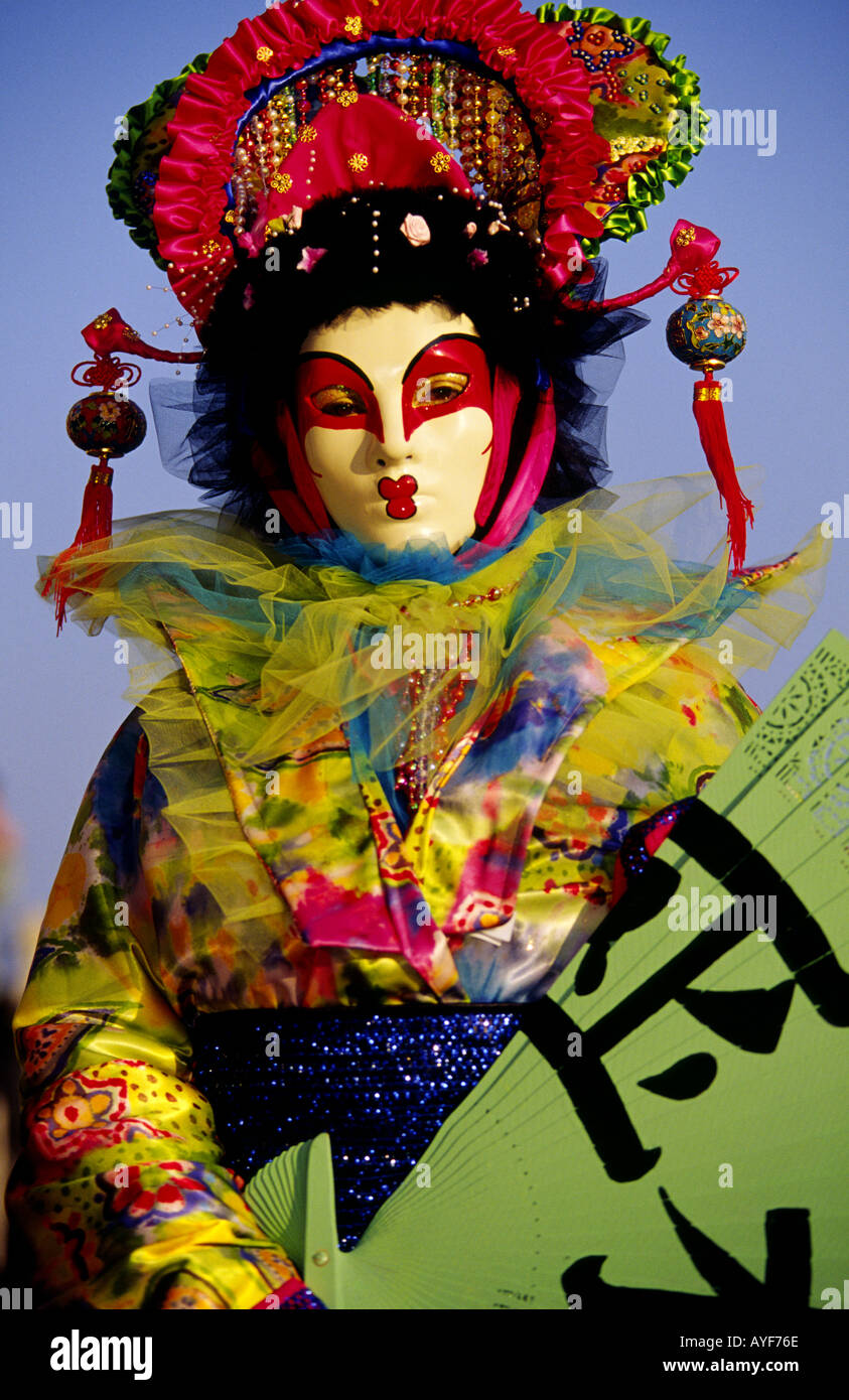 Dressed as Japanese oriental Geisha in red and light green with fan ...