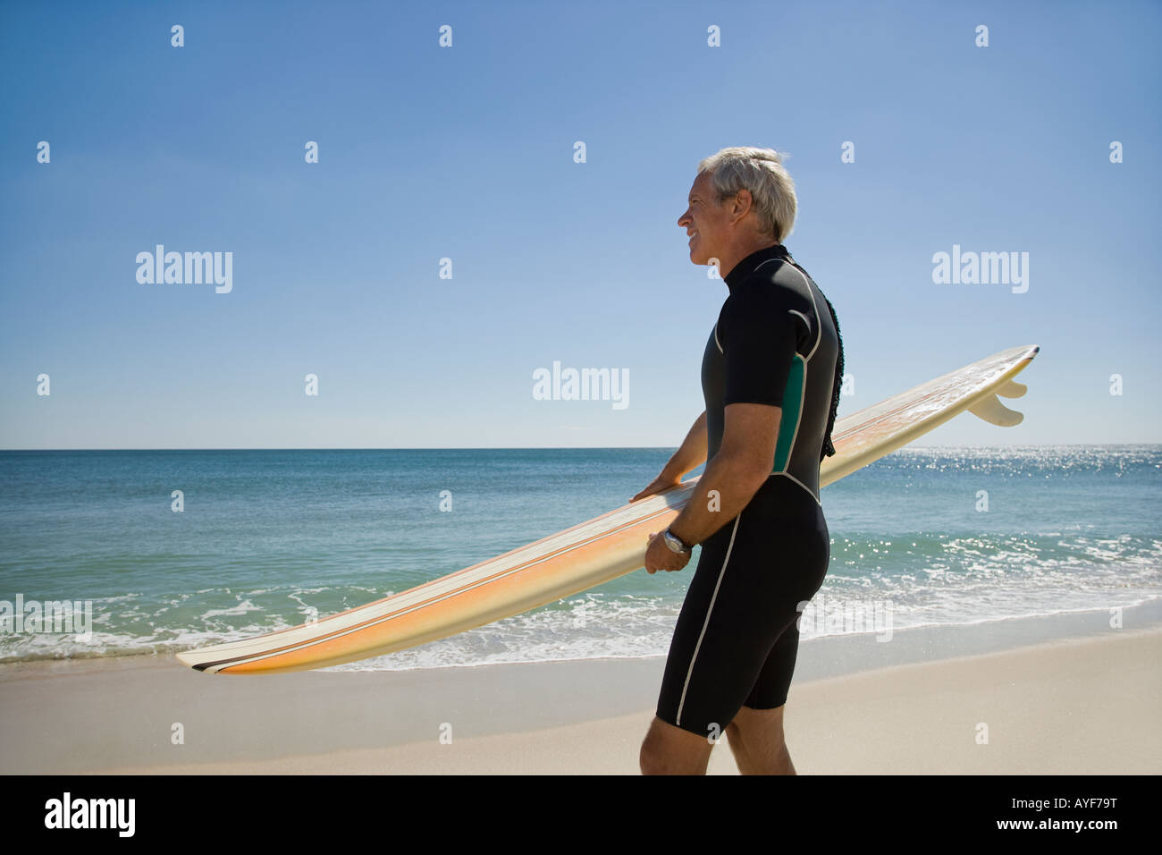 Man holding surfboard at beach Stock Photo - Alamy