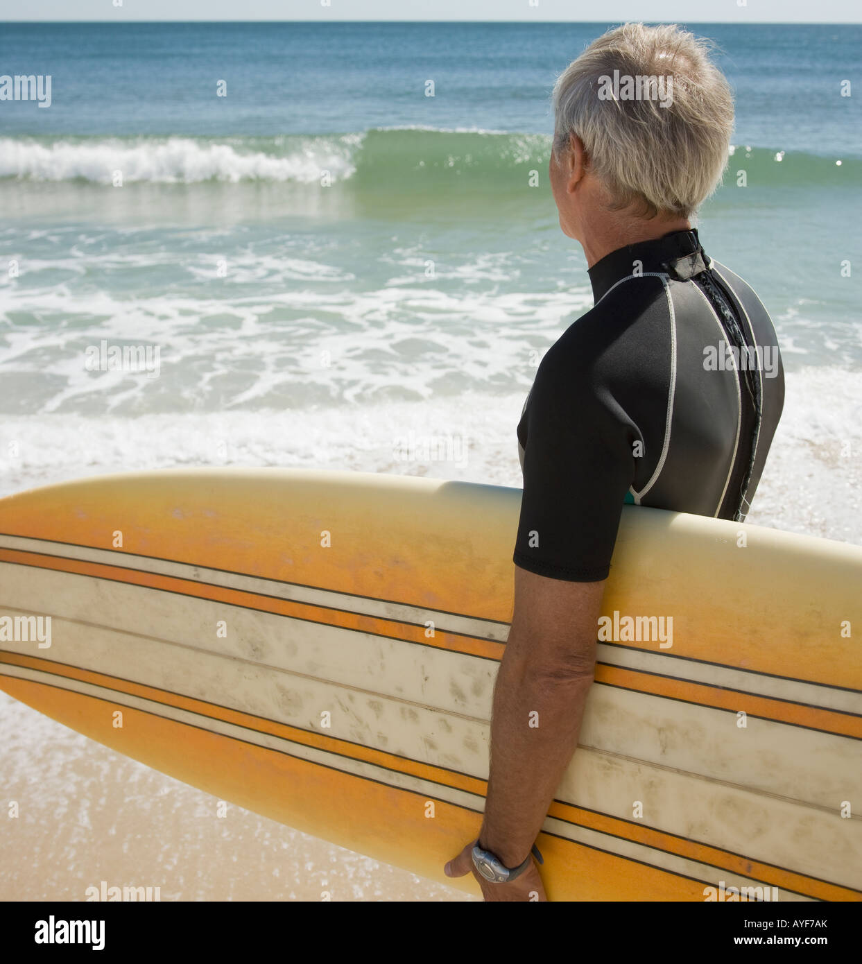Man holding surfboard at beach Stock Photo - Alamy