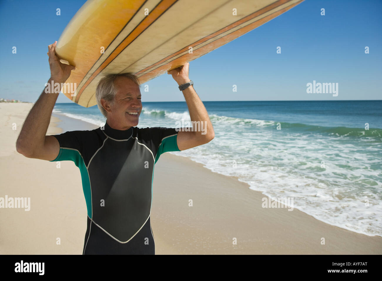 Man holding surfboard at beach Stock Photo - Alamy