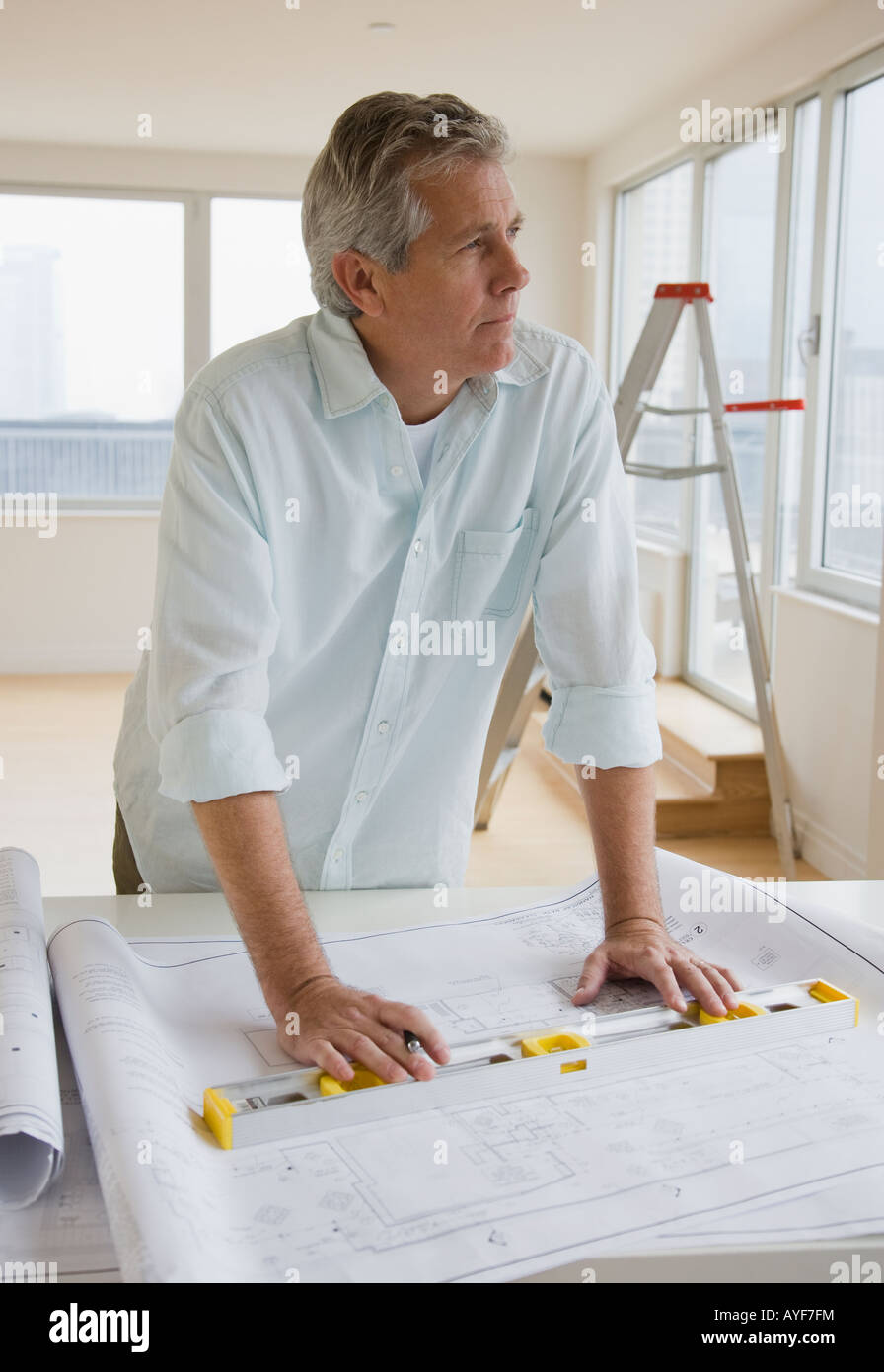 Man with level and blueprints Stock Photo - Alamy