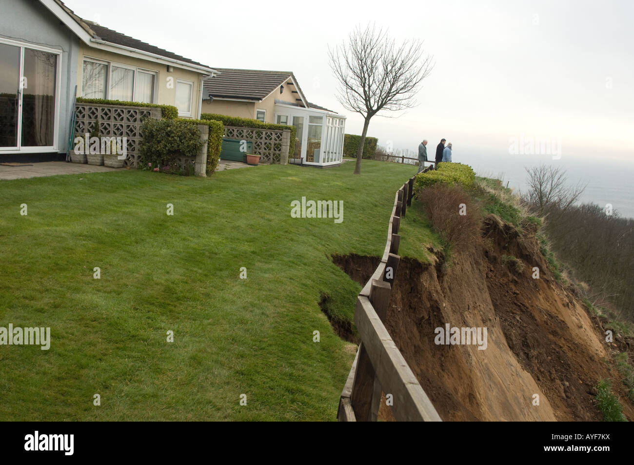Residents looking down from cliff landslide debris at Knipe Point ...