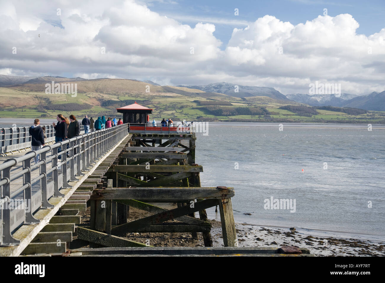 Beaumaris pier, Anglesey looking towards mountains of Snowdonia in ...