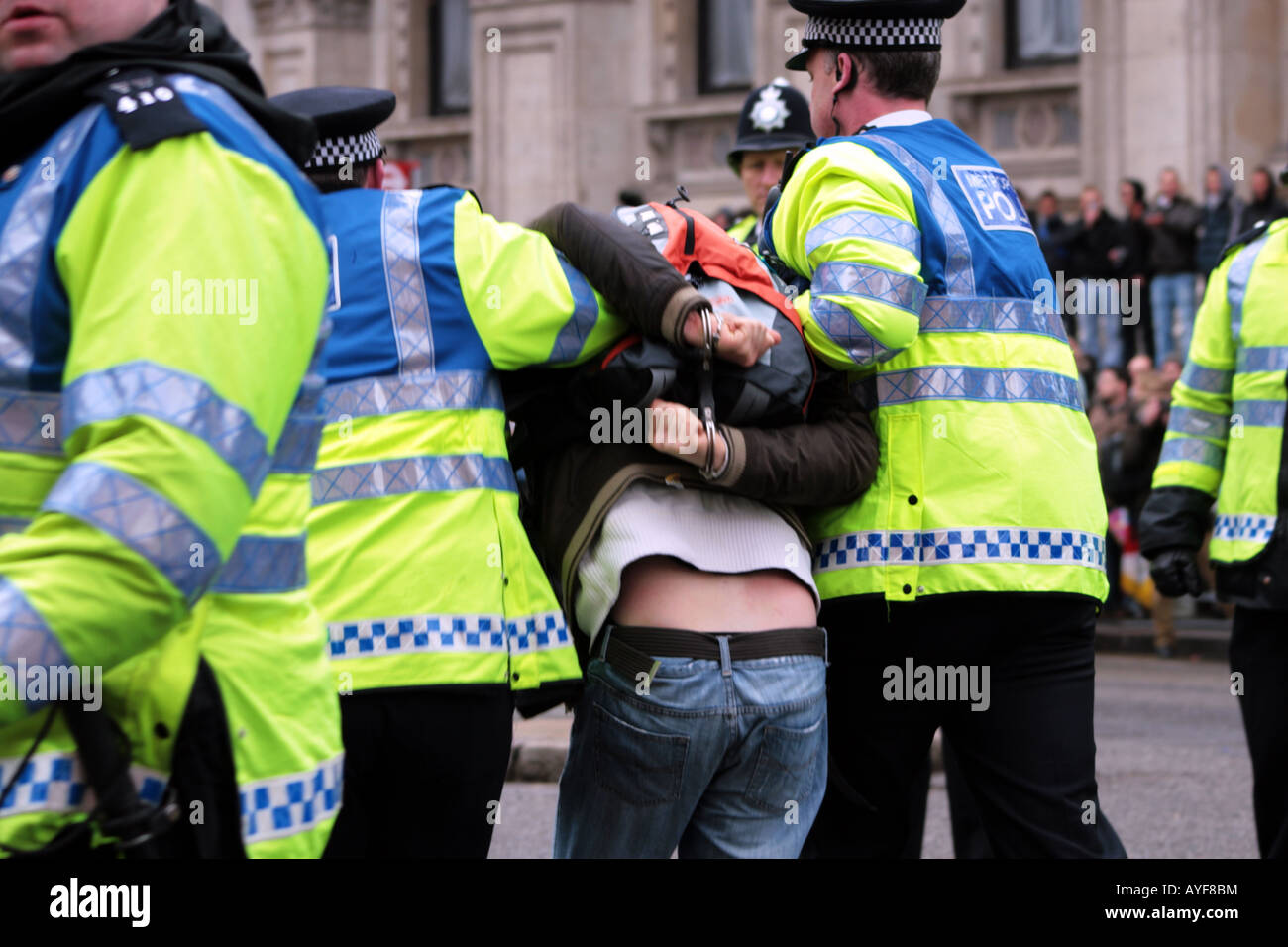 Police detain a human rights activist in London's Whitehall during anti ...