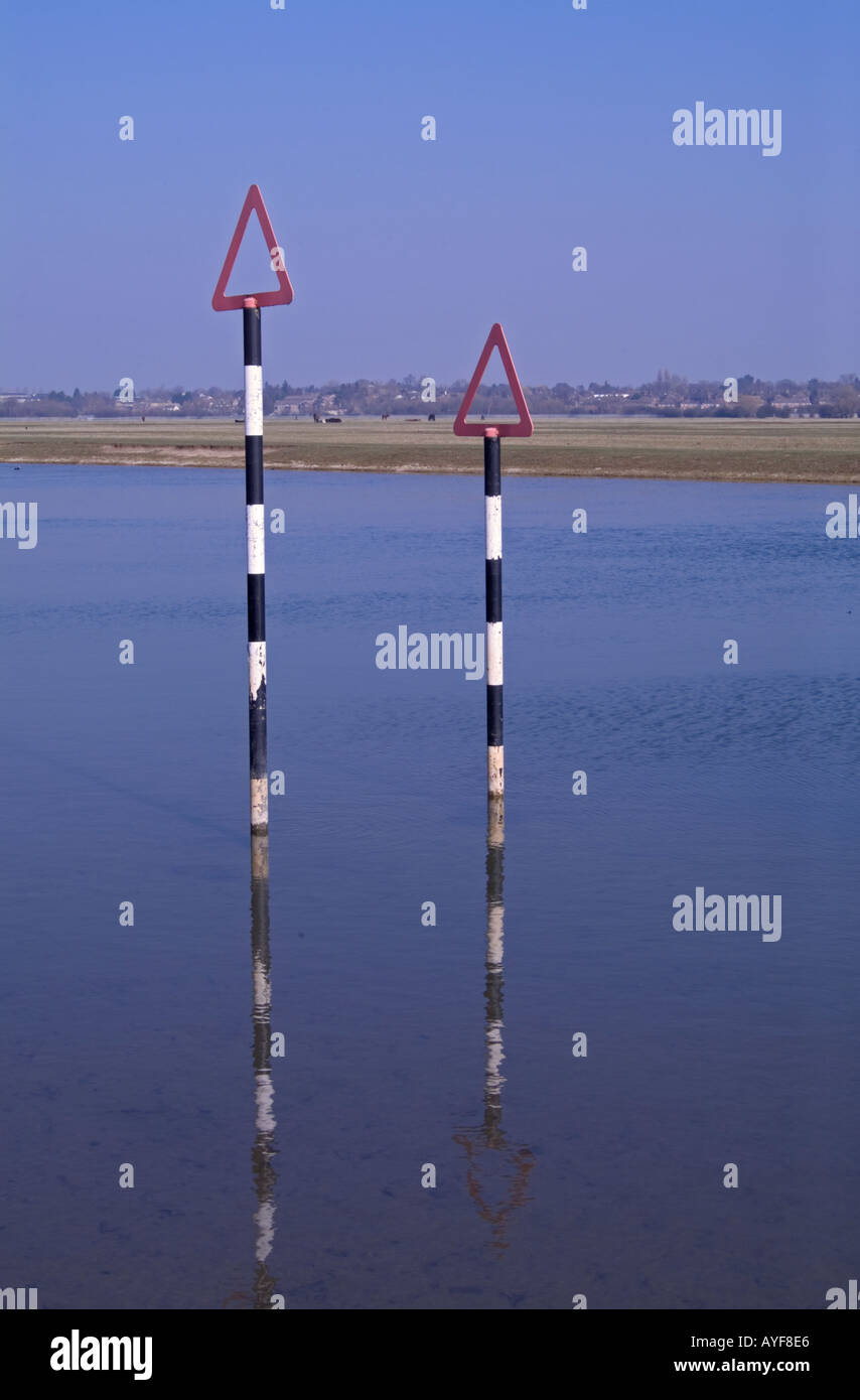 Triangular warning signs on poles in the Thames Port Meadow Oxford ...