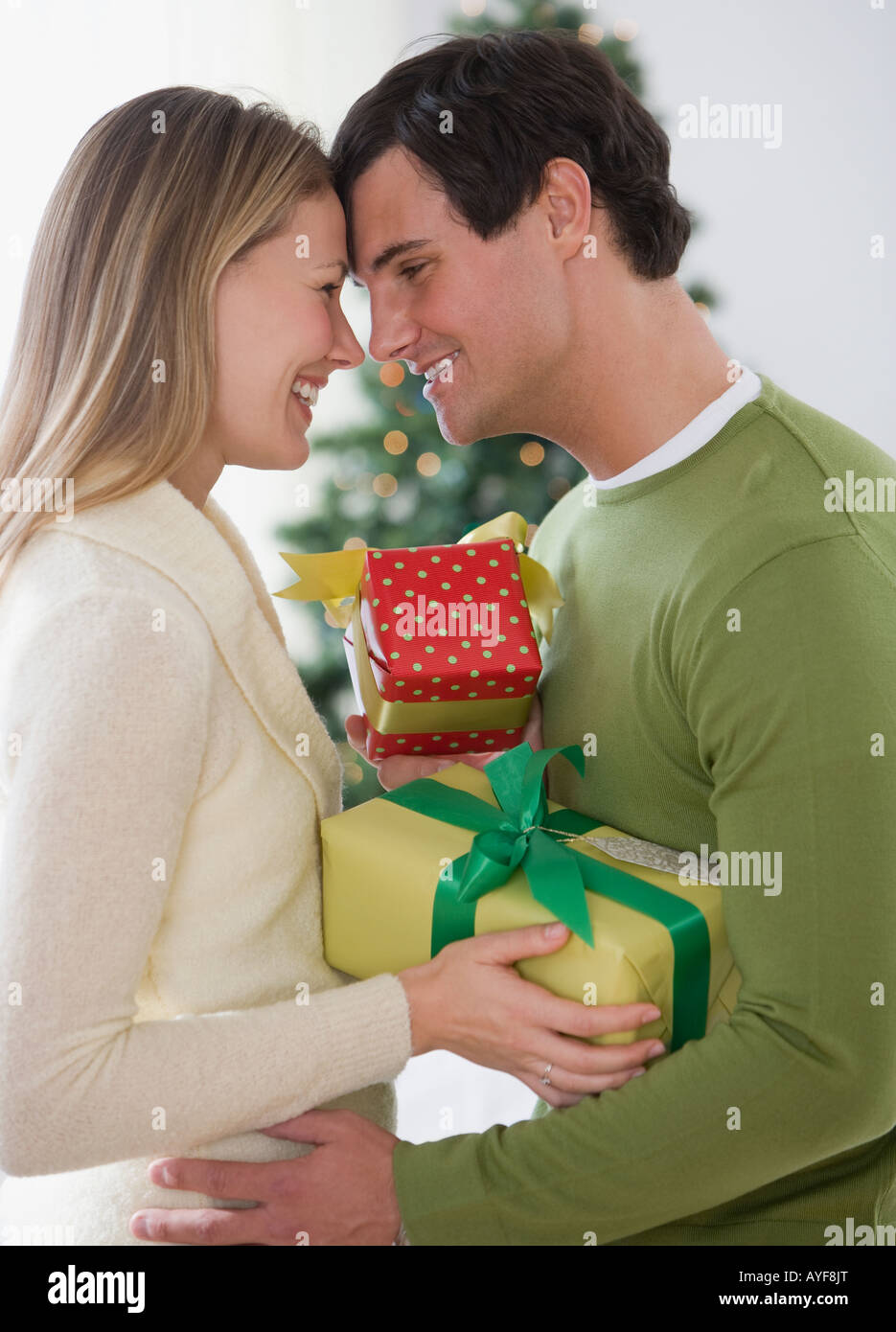 Couple with gifts hugging Stock Photo - Alamy