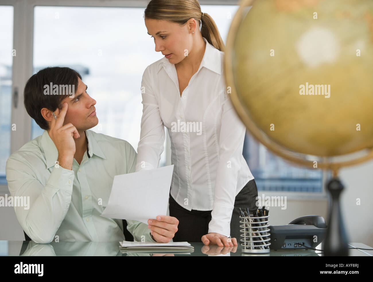 Businesspeople discussing paperwork Stock Photo - Alamy