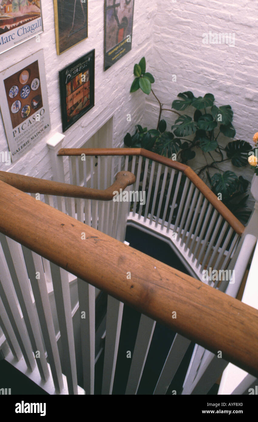 Aerial view of staircase with pictures on white painted brick wall ...