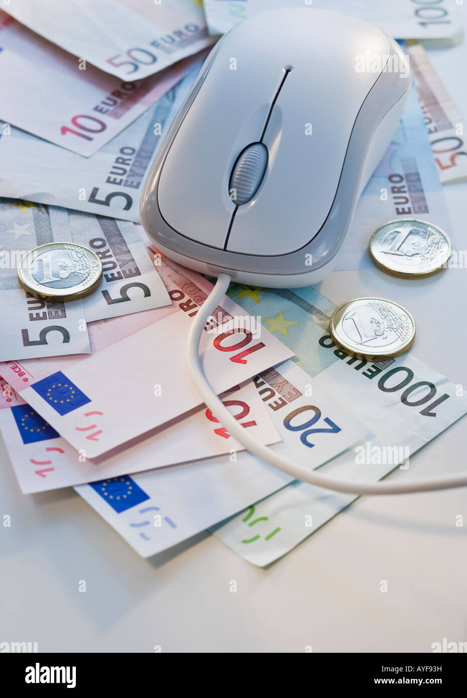 Computer mouse on euro banknotes and coins Stock Photo - Alamy
