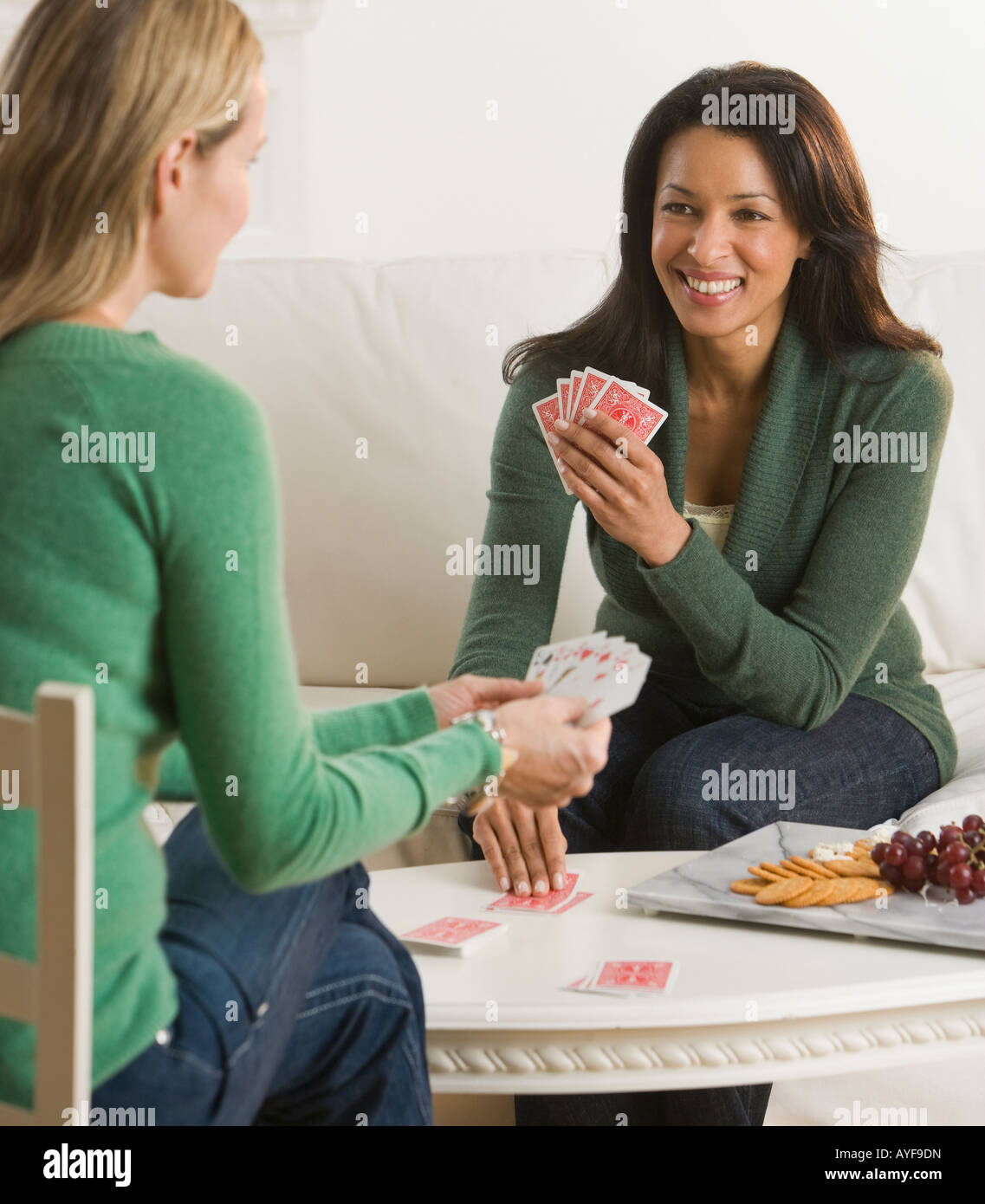 Multi-ethnic women playing cards Stock Photo - Alamy