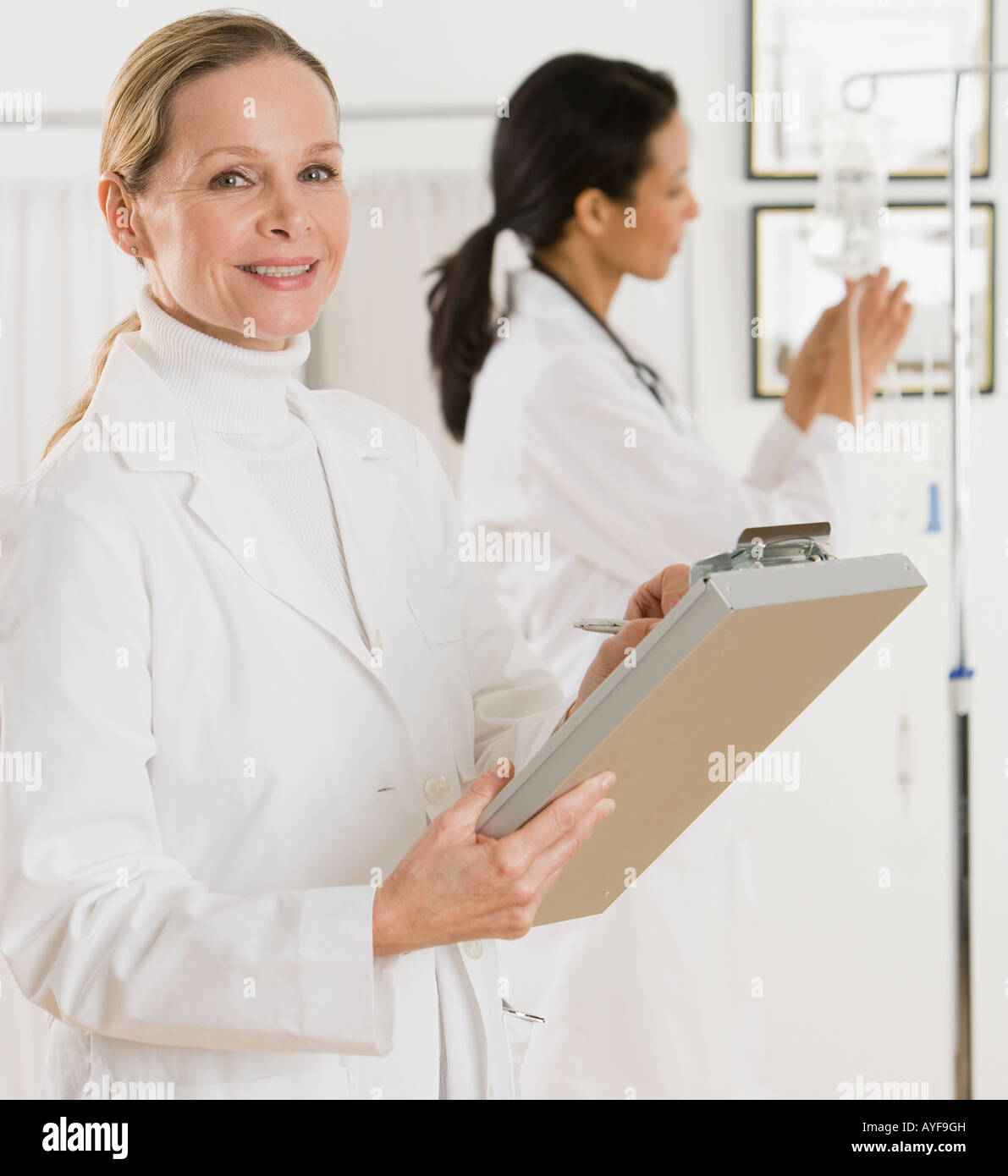Female doctor writing on chart Stock Photo - Alamy