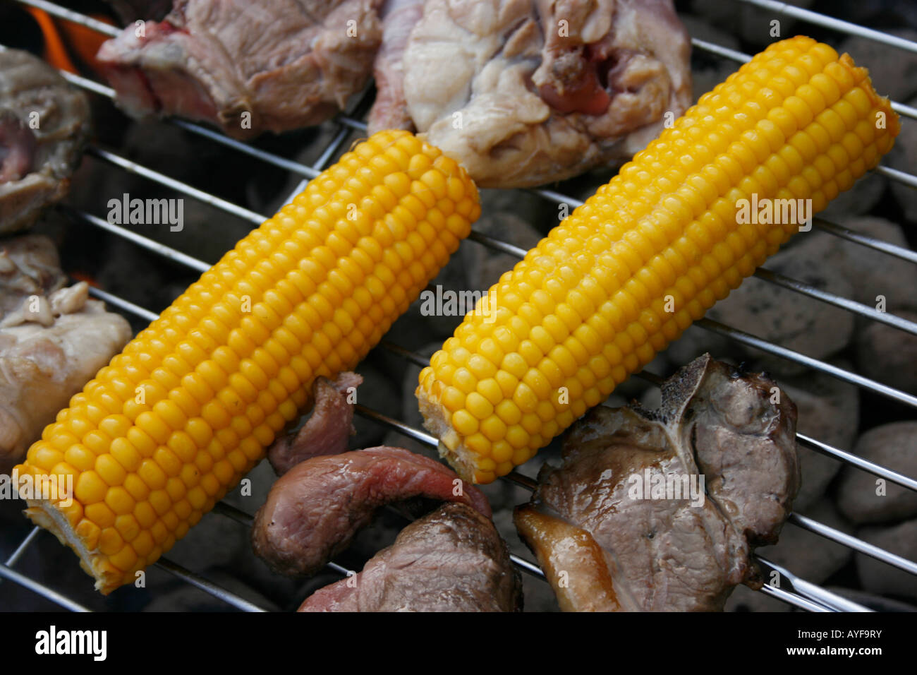 Corn on the cob cooking on a barbecue Stock Photo - Alamy