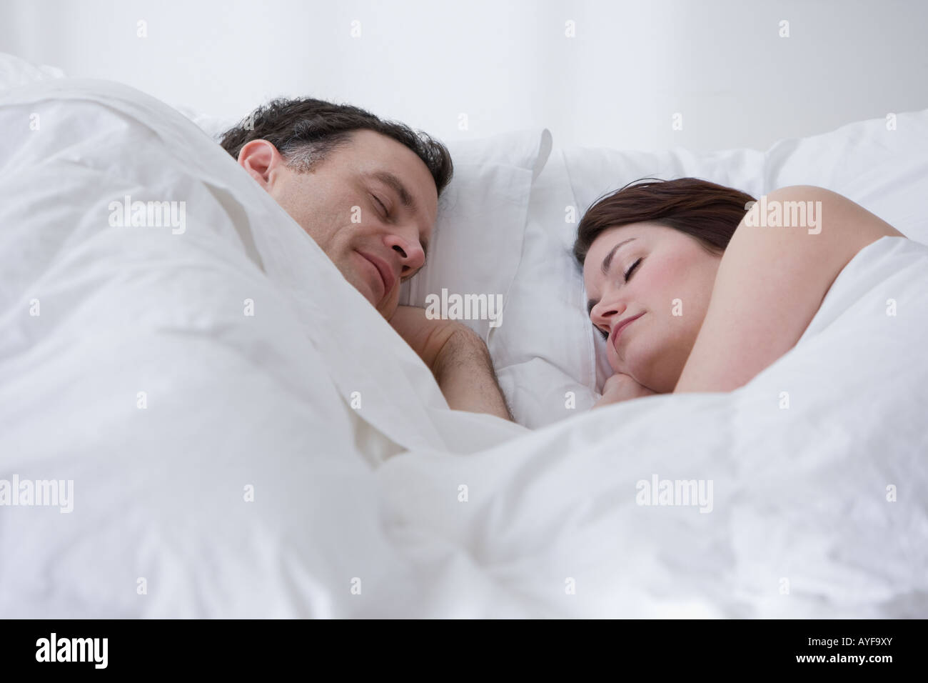Couple sleeping in bed Stock Photo - Alamy