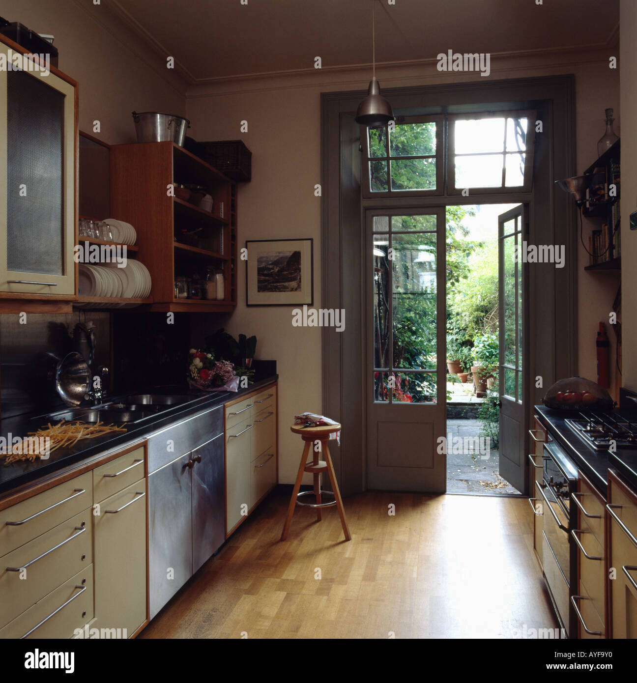 Wooden floor in modern kitchen with view through glass doors to ...