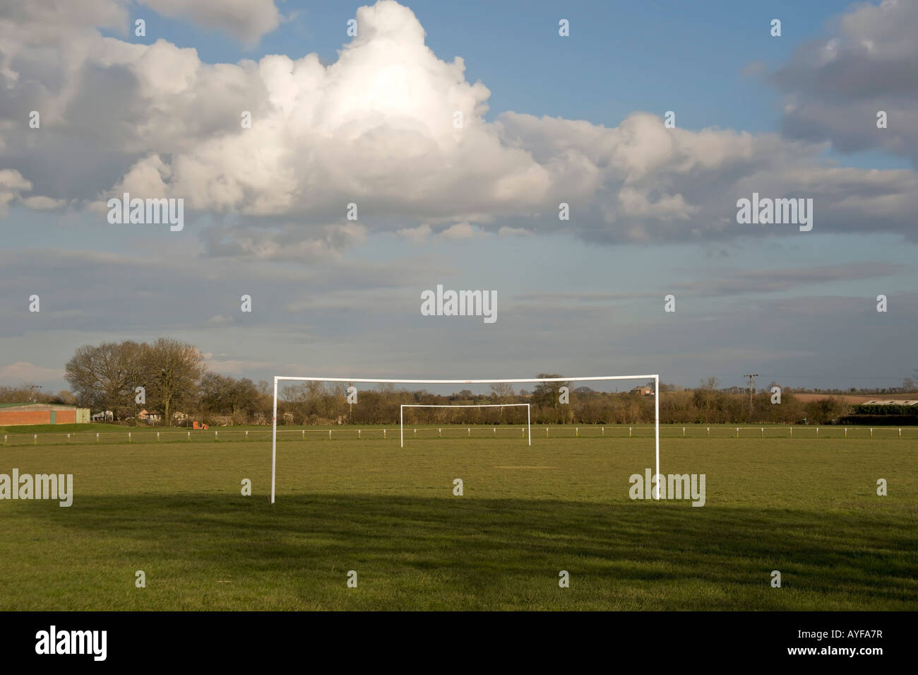 Two goalposts on an empty football pitch Stock Photo - Alamy