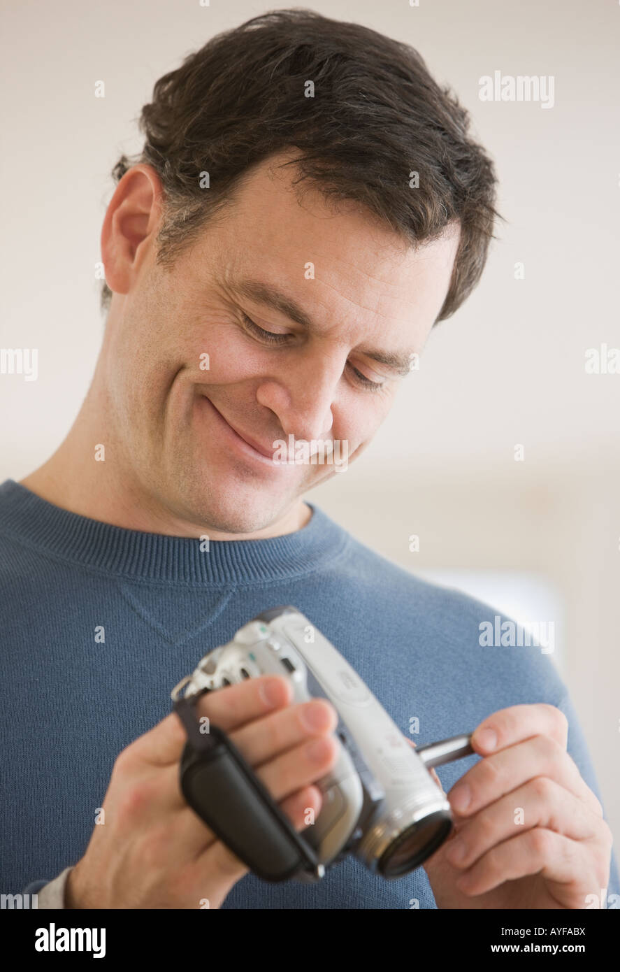Man looking at video camera Stock Photo - Alamy