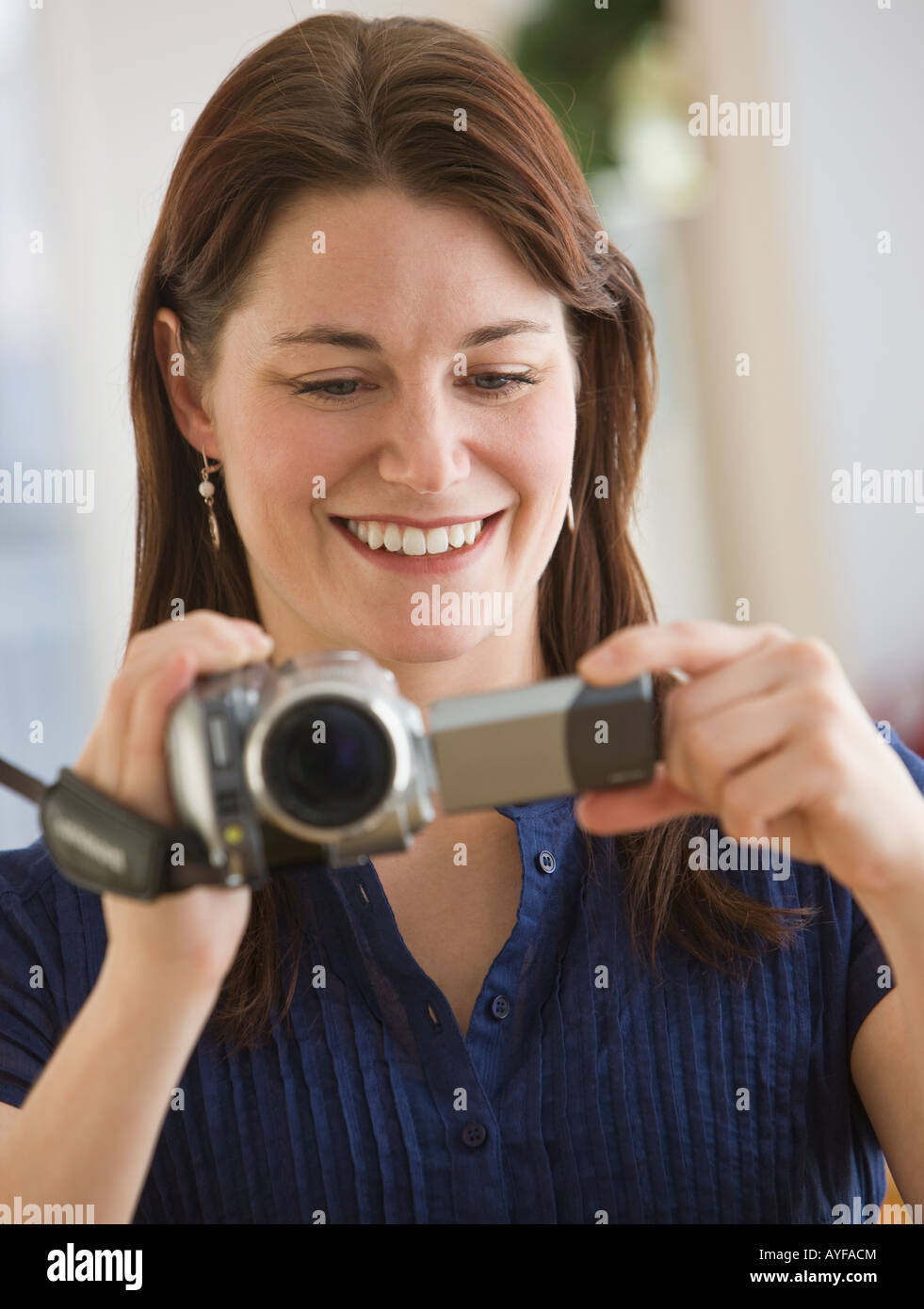 Woman looking at video camera Stock Photo - Alamy